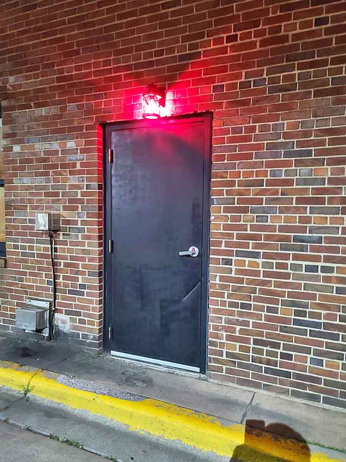 The entrance that started it all &ndash; That same black door seen from outside, now illuminated by the red glow that serves as the only hint of the magic waiting inside.