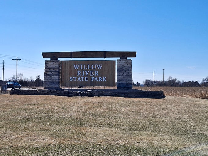 The park entrance welcomes visitors with rustic stonework, setting the tone for the natural beauty waiting just beyond the sign.