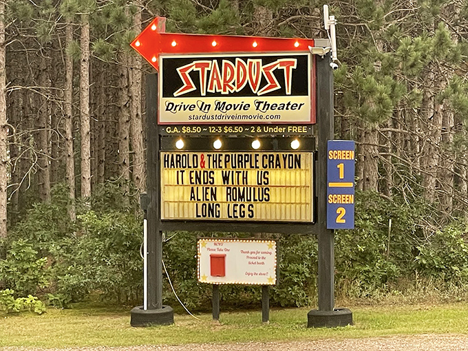 The illuminated marquee announces current features, guiding movie lovers to their evening entertainment destination.