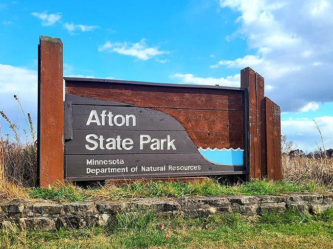 More than just a sign, this wooden marker serves as a portal between everyday life and the natural sanctuary waiting beyond.