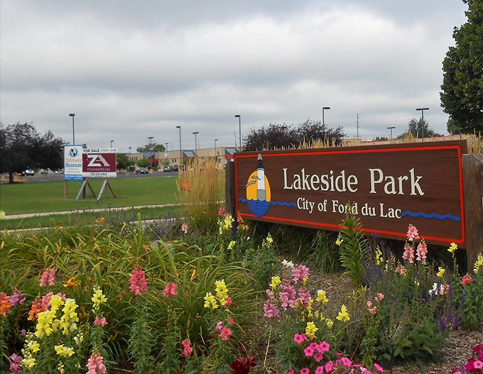 The welcoming sign that promises adventure beyond &ndash; surrounded by flowers that seem to say, "You've made an excellent choice stopping here."