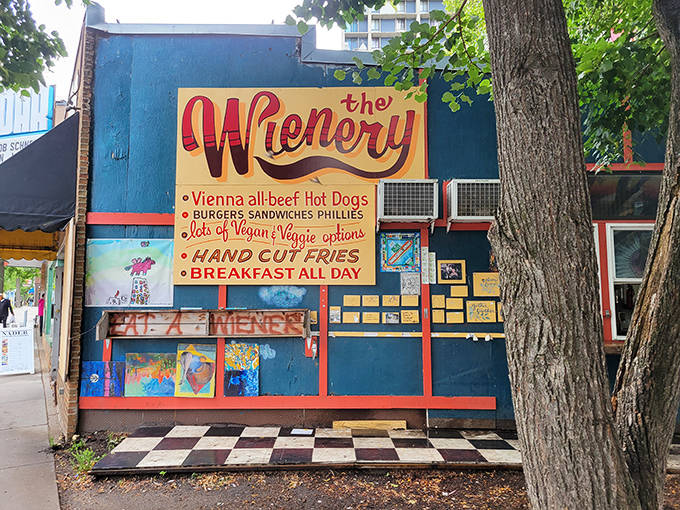 The weathered signage proudly announces The Wienery's specialties &ndash; Vienna beef hot dogs, burgers, sandwiches, and plenty of vegan options for all.