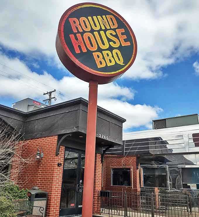 Even on cloudy days, the Round House BBQ sign shines like a beacon, guiding hungry travelers to their smoky salvation in Trenton.