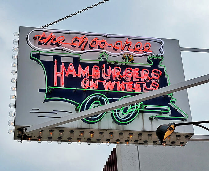 The neon sign glows like a beacon for the hungry and the nostalgic, promising "Hamburgers on Wheels" and delivering on that delicious pledge.