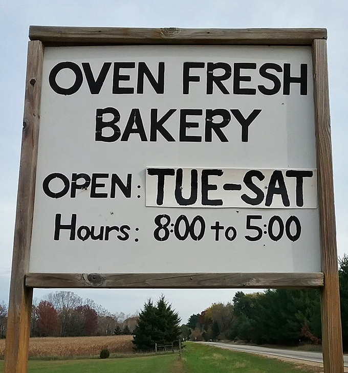 The bakery sign announcing hours &ndash; a simple promise of Tuesday through Saturday delights that locals plan their weeks around.