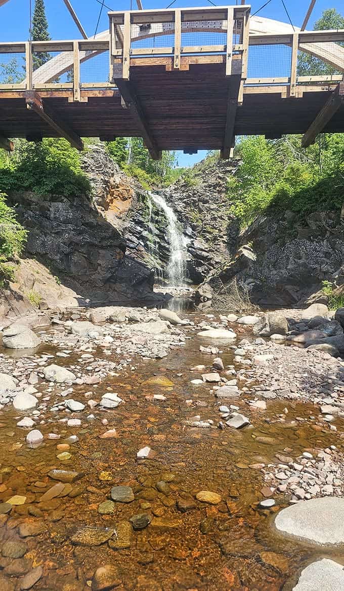 Standing beneath the bridge looking up at the falls creates that rare perfect moment when everything aligns just right.