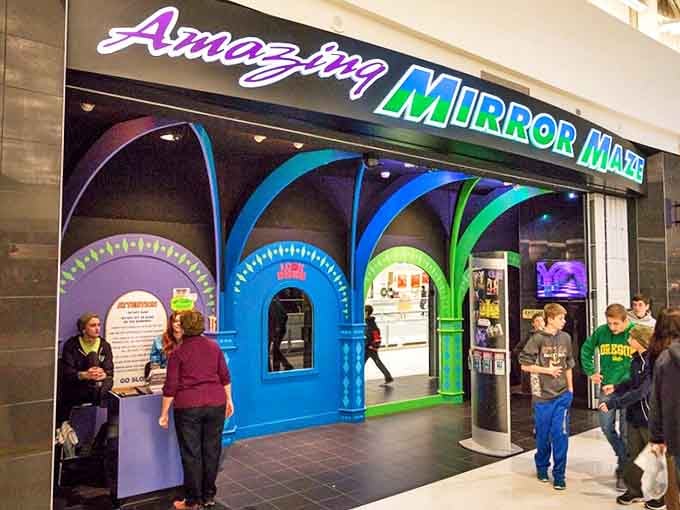 The vibrant entrance to the Amazing Mirror Maze beckons mall-goers with a rainbow of archways promising disorientation and delight.