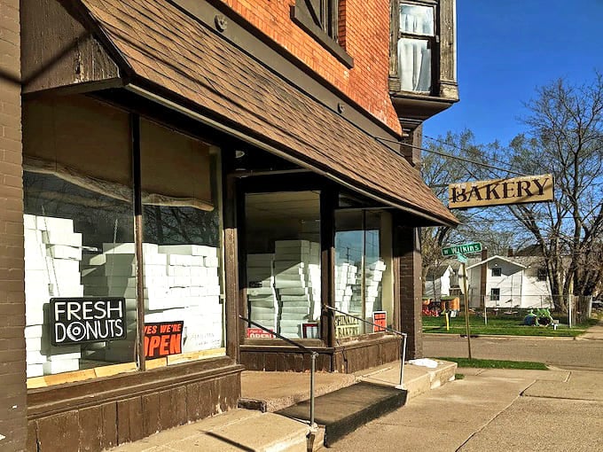 Hinkley Bakery's charming storefront promises sweet treasures inside, with windows stacked high with their famous white donut boxes.