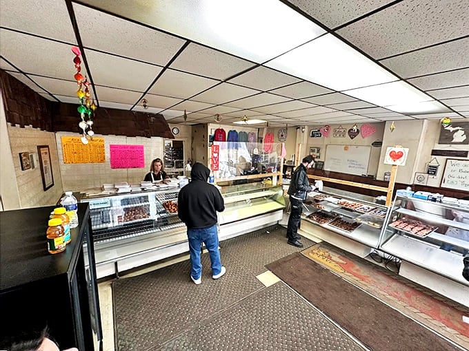 Inside Hinkley's, customers browse glass cases filled with freshly made donuts and pastries that locals line up for daily.