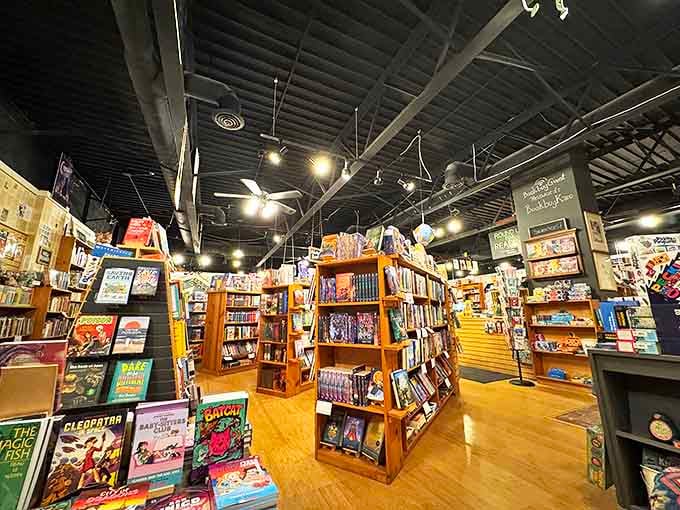 Wooden shelves create literary canyons under exposed beams, inviting browsers to get happily lost among thousands of carefully curated volumes.