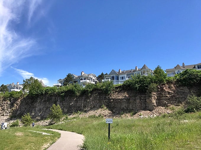 Elegant homes perch precariously on limestone cliffs, their manicured lawns ending where gravity begins &ndash; nature's version of waterfront real estate roulette.