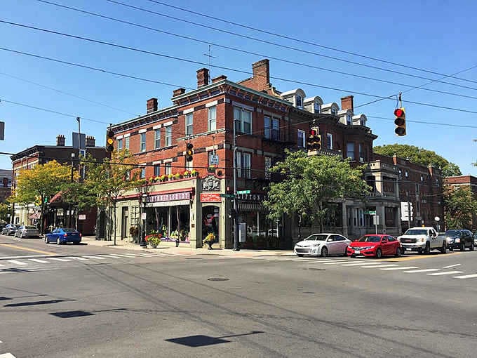 Brick buildings standing shoulder to shoulder like old friends, telling stories of commerce, community, and countless Sunday strolls.
