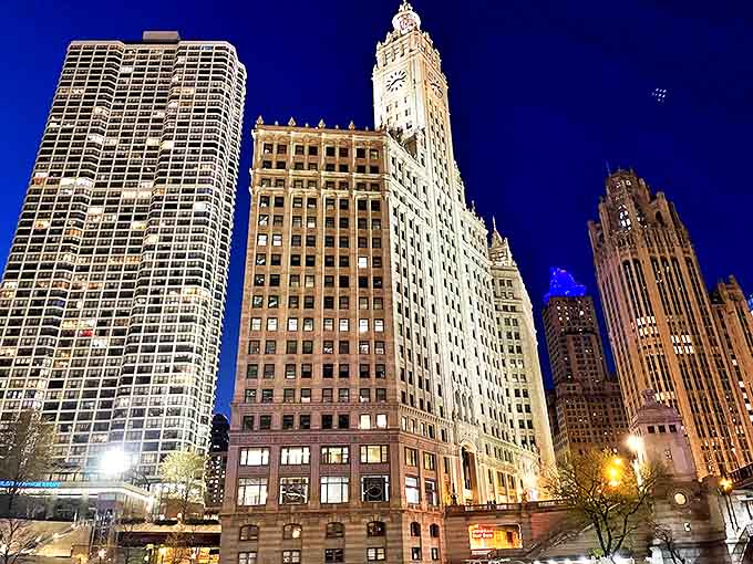 The iconic Wrigley Building clock tower stands sentinel over the river, its gleaming white terra cotta catching the light like a beacon for river travelers.