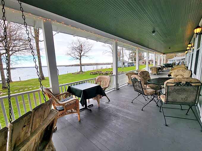 Morning coffee achieves transcendence on this covered veranda, where rocking chairs and lake views conspire to make time stand deliciously still.