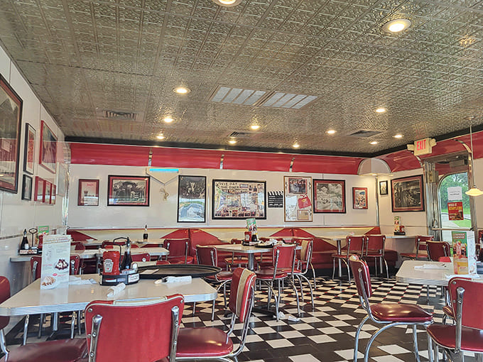 Classic red vinyl booths and checkerboard floors create that authentic diner atmosphere where conversations flow as freely as the coffee.