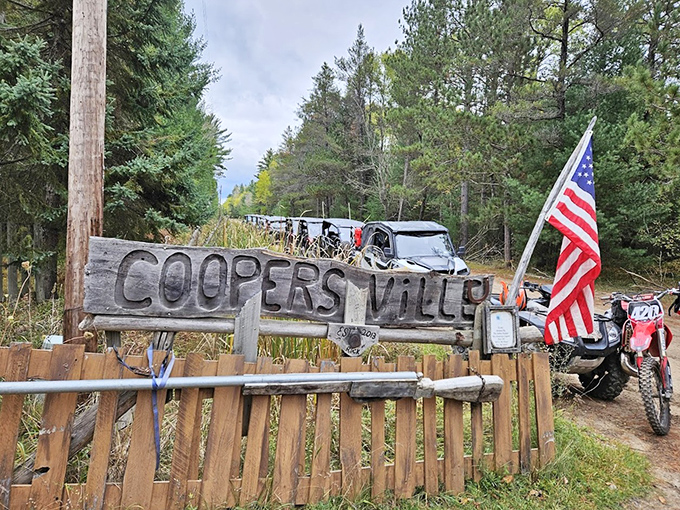 That hand-carved "COOPERS VILLE" sign is like a portal to another era, complete with Old Glory standing guard.
