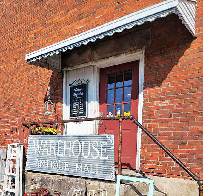 The welcoming entrance beckons visitors with its vintage charm – that red door isn't just an entrance, it's a portal to yesteryear.