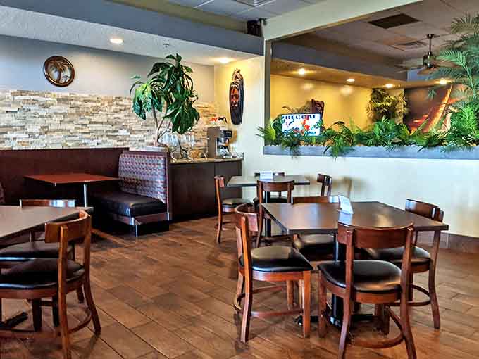 Inside, tropical plants and stone accents transform a simple dining room into a cozy Caribbean escape from Michigan's reality.