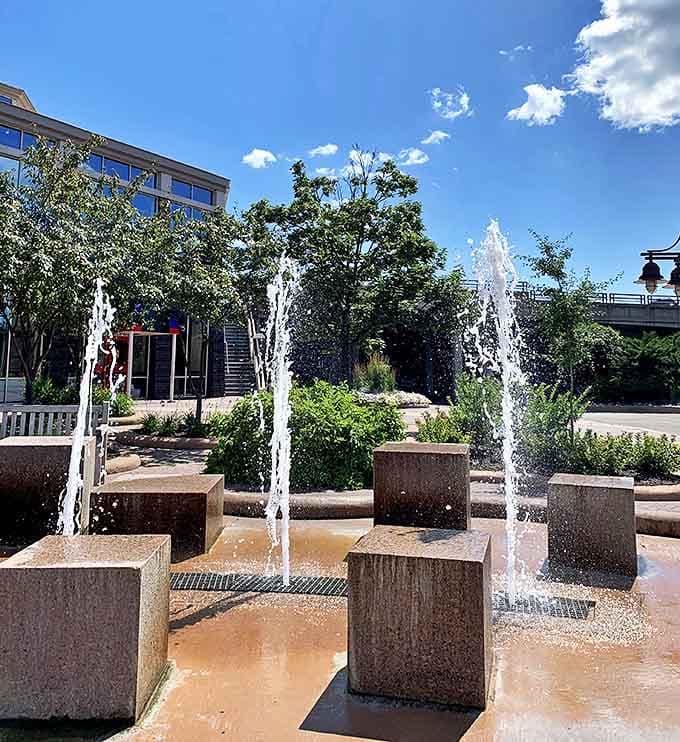 The dancing fountains create a cooling spectacle on hot summer days, with geometric stone blocks playing host to vertical streams that hypnotize passersby.