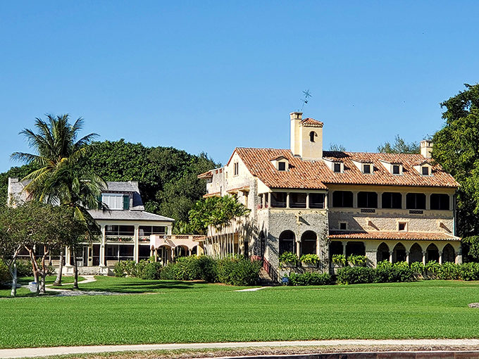 Bathed in Florida sunshine, the estate's front view showcases perfect symmetry between architectural grandeur and natural splendor.