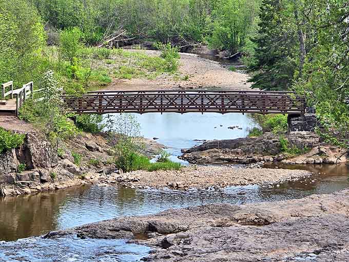 A rustic footbridge spans the Gooseberry River, offering the perfect vantage point for contemplating life's big questions or just enjoying the view.