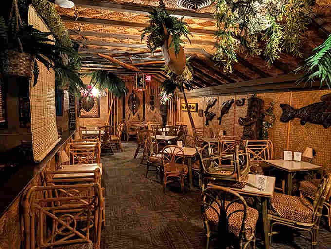 Bamboo paradise awaits inside, where rattan furniture, thatched ceilings, and ambient lighting transport you thousands of miles from Illinois without a single boarding pass.