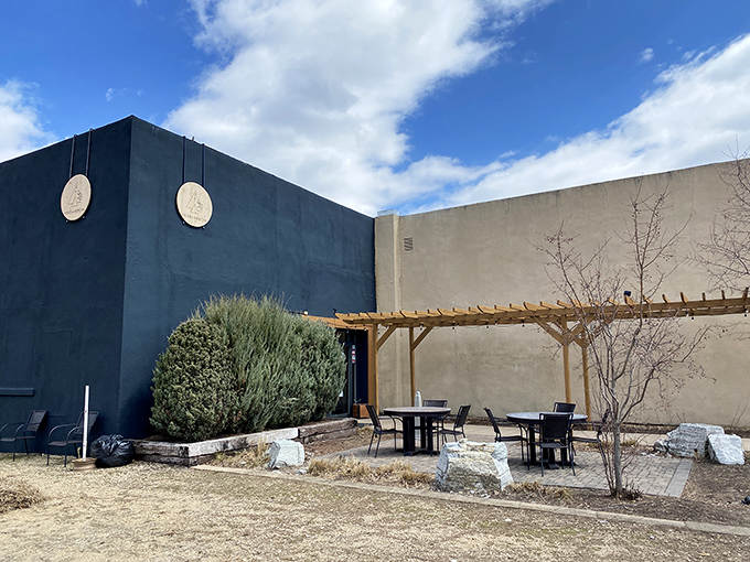 Herb + Arrow's minimalist blue exterior creates a desert oasis vibe, where contemporary design meets small-town charm in an unexpected riverside retreat.