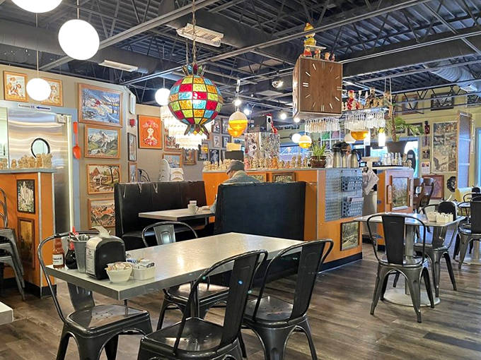 Step into a time capsule where vintage paint-by-numbers artwork covers every inch of wall space. The mismatched lighting fixtures dangle like quirky jewelry from the industrial ceiling.