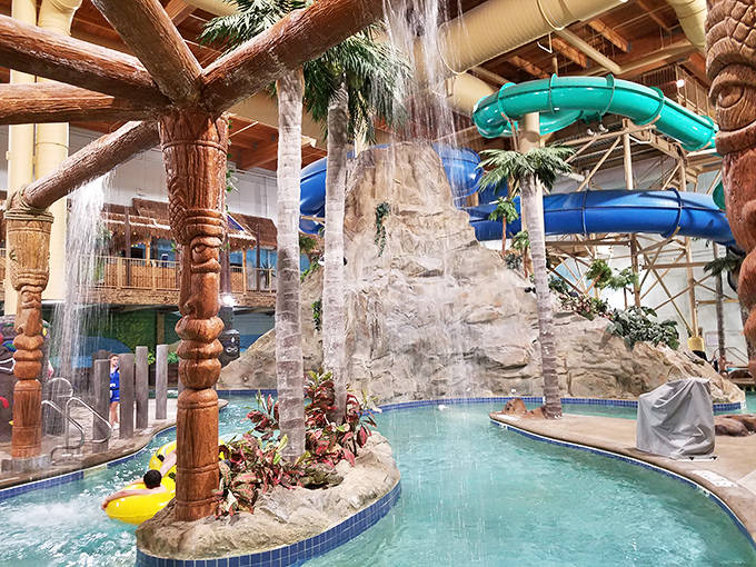 Towering waterslides twist through the air like colorful serpents, delivering riders into pools with the satisfying splash of pure joy.