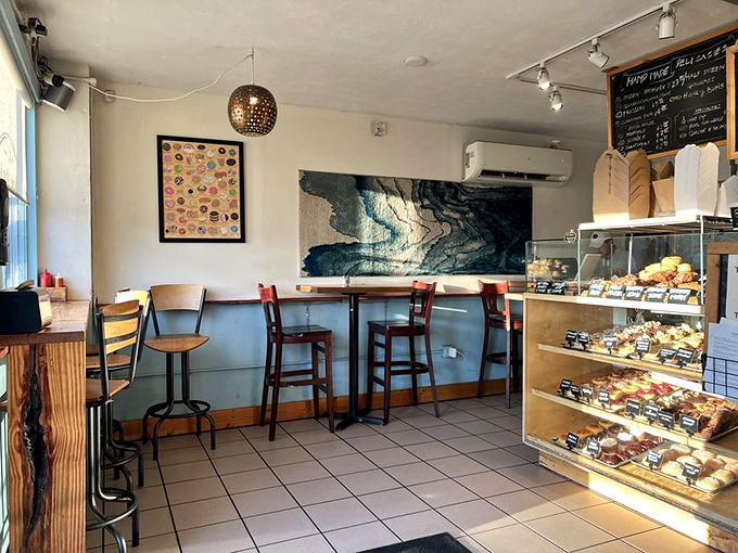 Inside this cozy haven, every detail speaks of thoughtful design – from the pendant light to the display case showcasing edible works of art.