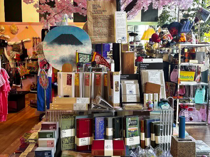 A treasure hunter's paradise where colorful notebooks, art supplies, and quirky decor items create an Instagram-worthy tableau of organized chaos.