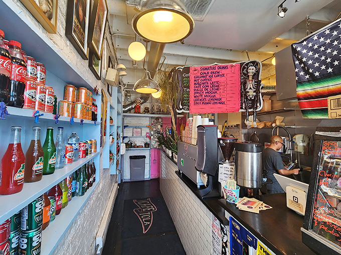 Narrow but mighty! The interior packs personality into every inch, with colorful sodas lining shelves and handwritten menus promising delicious adventures.