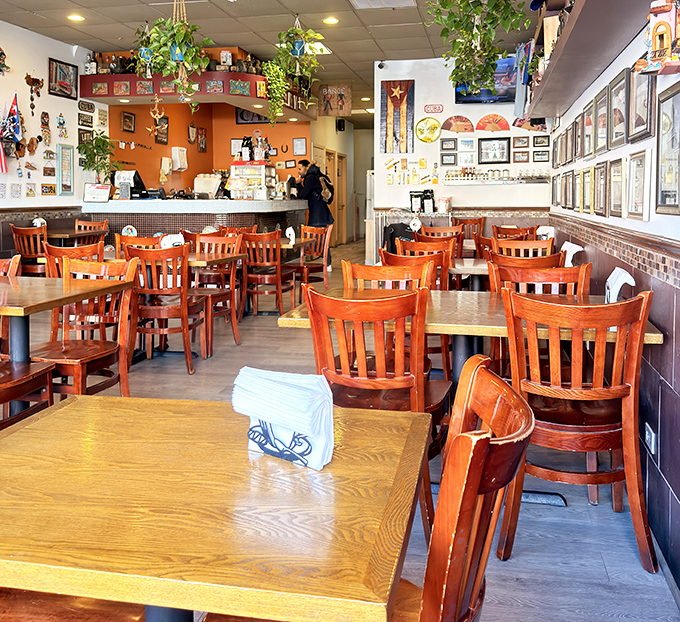 Wooden chairs and tables create a homey atmosphere where conversations flow as freely as the Cuban coffee.