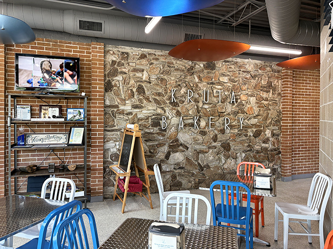 Stone meets brick in this cozy interior where colorful chairs invite you to sit and savor your treats in a space that balances modern charm with bakery tradition.