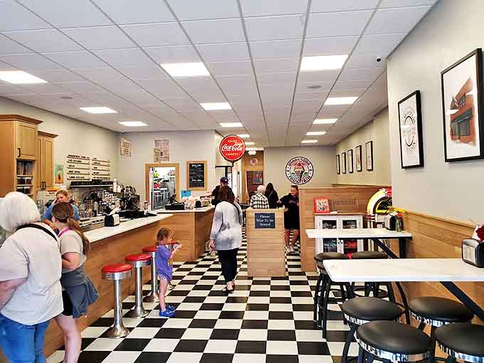 Black and white checkered floors meet classic red vinyl stools &ndash; this isn't manufactured nostalgia, it's the real deal, preserved perfectly.