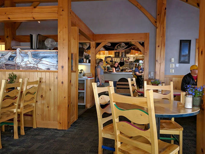 Warm wooden beams frame the dining room, where natural light pours through windows offering glimpses of Lake Superior's sparkling waters.
