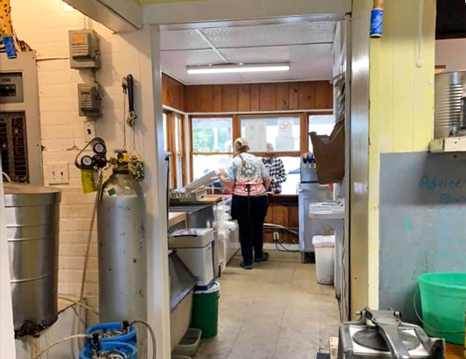 Behind the scenes magic: The compact kitchen where Pizza Burger dreams come true, efficiency in motion for decades of delicious service.