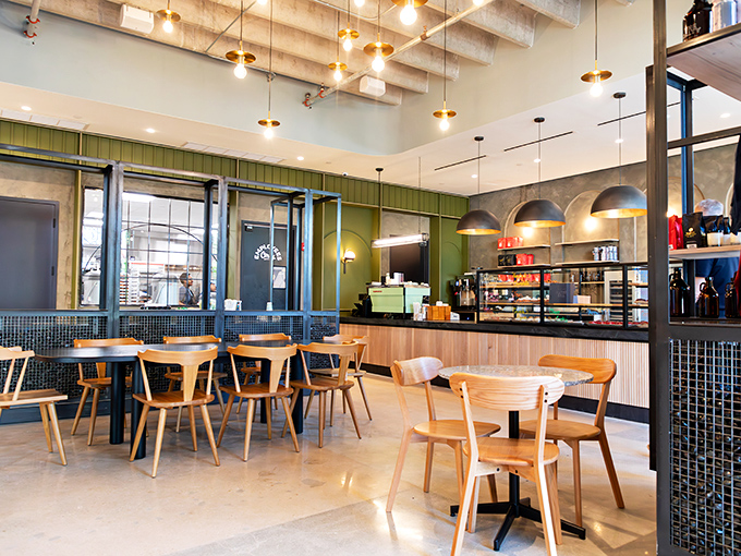 Modern meets cozy in this thoughtfully designed interior where pendant lighting casts a warm glow over wooden furnishings and concrete floors.