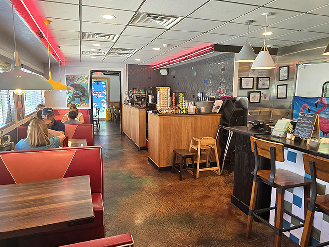 Red vinyl booths and neon lighting create that perfect retro atmosphere where calories don't count and conversations flow as smoothly as the coffee.