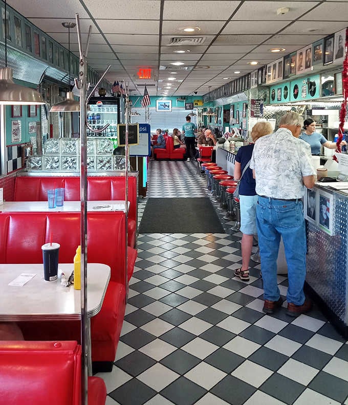 Inside, the classic checkered floor and red vinyl booths create the perfect backdrop for conversations that flow as freely as the coffee.