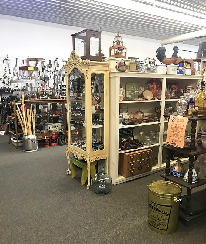 Shelves overflow with carefully curated collections where vintage finds create visual stories, each booth offering its own unique journey through decades of American history and craftsmanship.