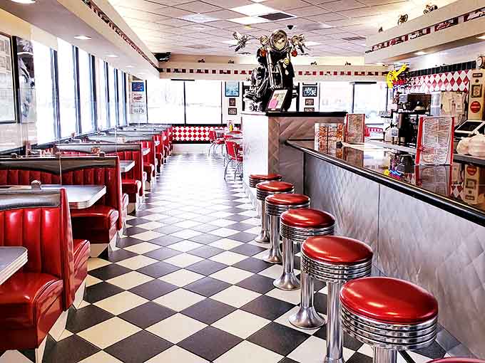 Classic black and white checkered floors meet cherry-red booths in this time capsule of Americana, where every corner whispers stories of simpler times.