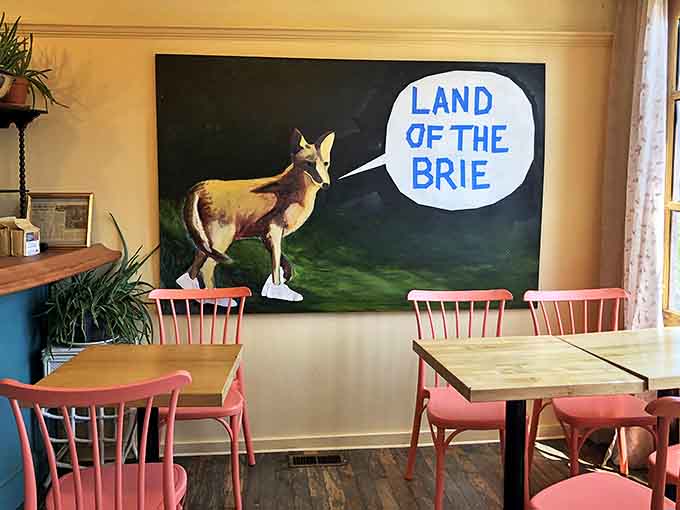 Inside, whimsical art declares this the "Land of the Brie" while pink chairs invite you to settle in for a meal that transcends ordinary breakfast expectations.