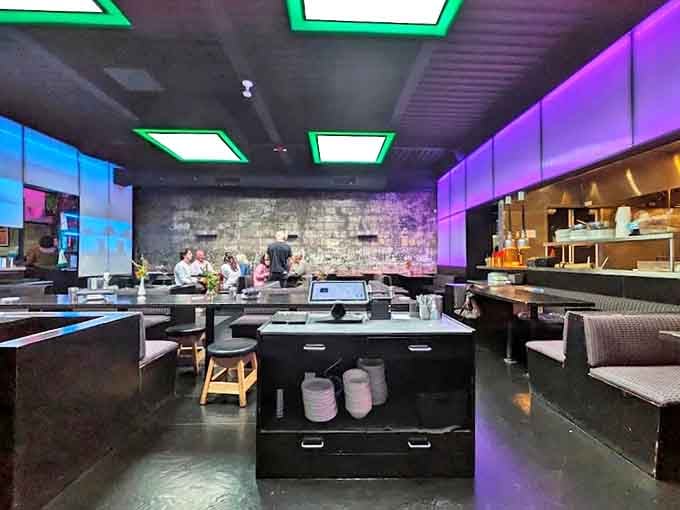 Inside Takoi, moody lighting transforms brick walls into a canvas of purple and blue &ndash; dining room or art installation? Both!