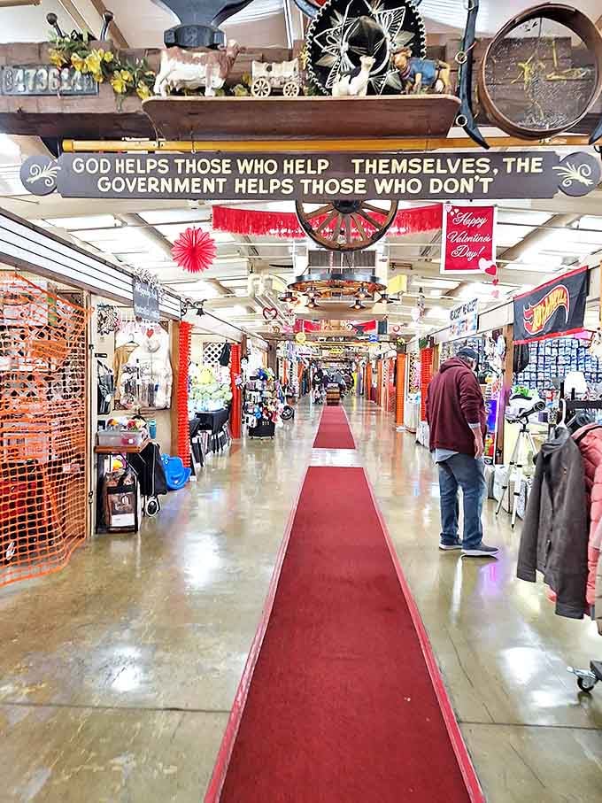 The red-carpeted main aisle stretches into infinity, with overhead signs proclaiming folksy wisdom and shoppers hunting for their next great find.