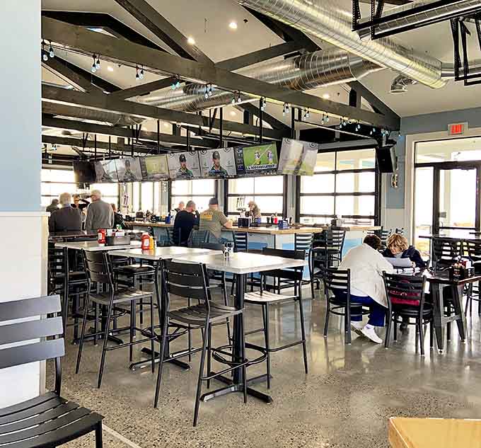 Industrial-chic meets lakefront luxury in this airy dining space where exposed beams and natural light create the perfect backdrop for memorable meals.