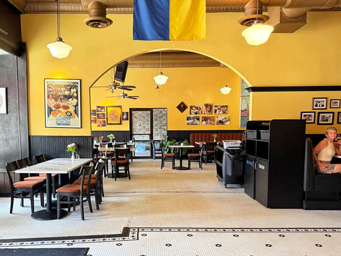 Warm yellow walls and classic fixtures create an atmosphere that's both nostalgic and welcoming, with the Ukrainian flag proudly displayed.