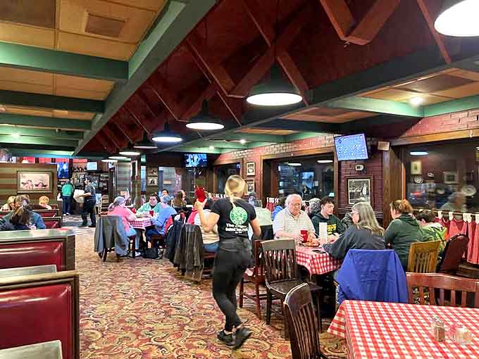 Inside Cloverleaf, red-checkered tablecloths and warm wood paneling create that "everybody knows your name" vibe where pizza memories are made daily.