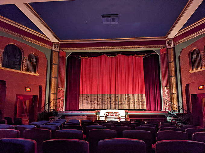 Rich red curtains frame the stage while ornate details transport viewers to cinema's golden age &ndash; no time machine required.