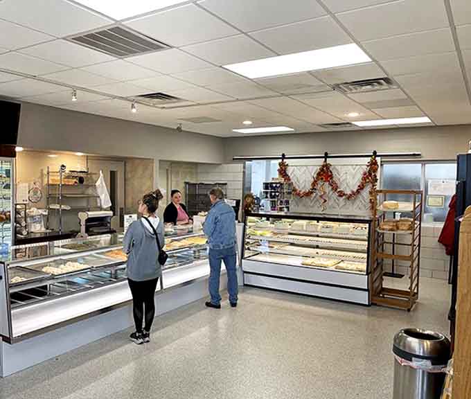 Inside, the gleaming display cases showcase an edible art gallery where diet plans come to die happy, delicious deaths.